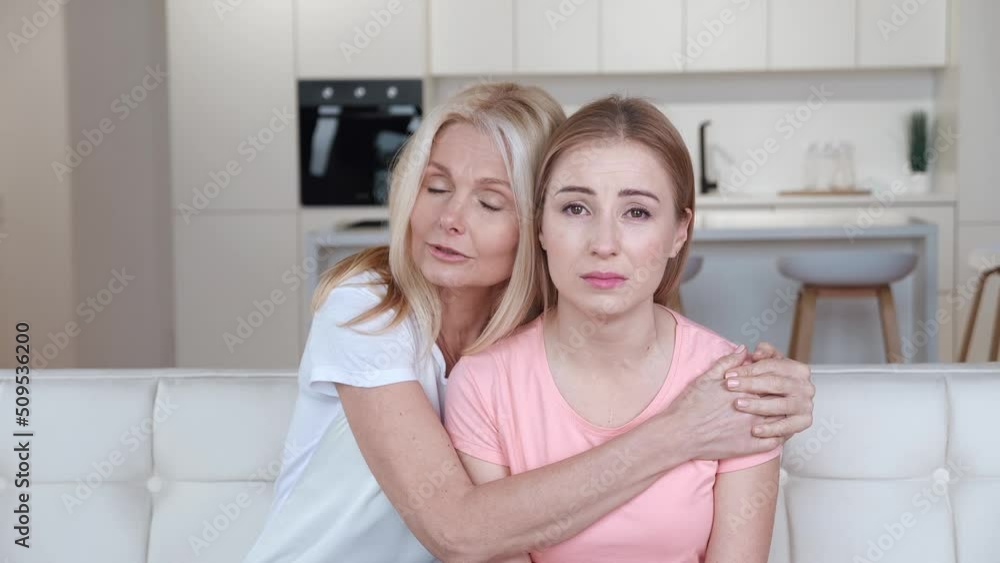 Loving senior mother sympathizing sad depressed young adult daughter ...