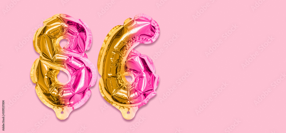 Rainbow foil balloon number, digit eighty six on a pink background ...