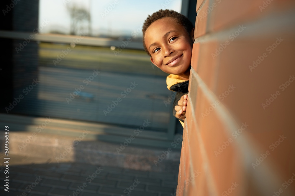 Horizontal outdoor image of happy funny african american kid playing ...