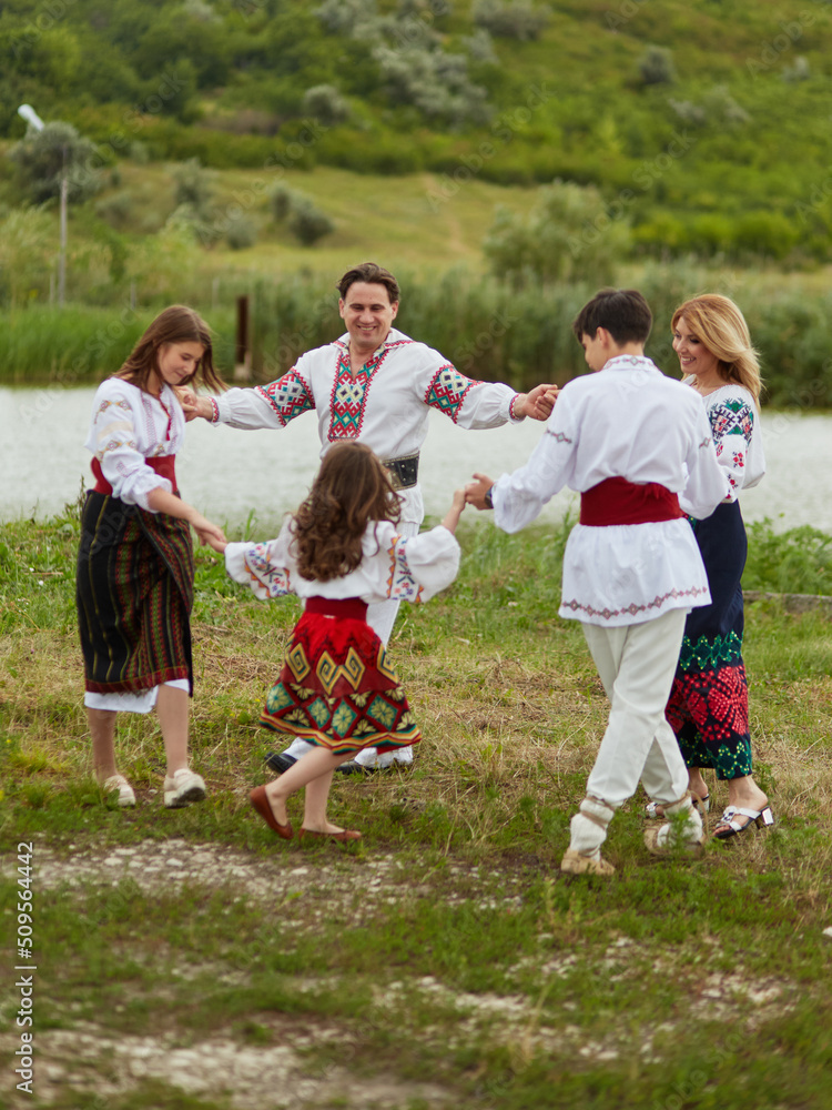 Full length image of a family with kids in traditional romanian dress ...