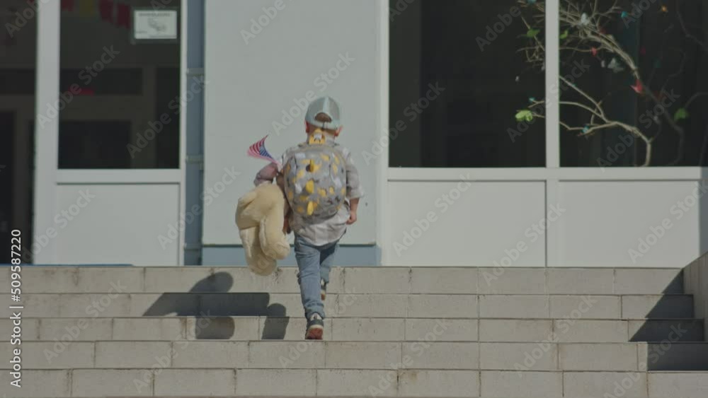 child kid boy in blue cap, backpack with USA flag, holding teddy bear ...