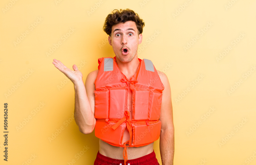 young handsome guy looking surprised and shocked, with jaw dropped ...