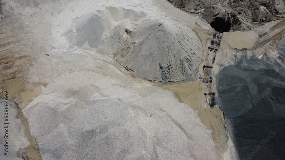 An aerial view of the piles of fine stone in the quarry. Fine stone is ...