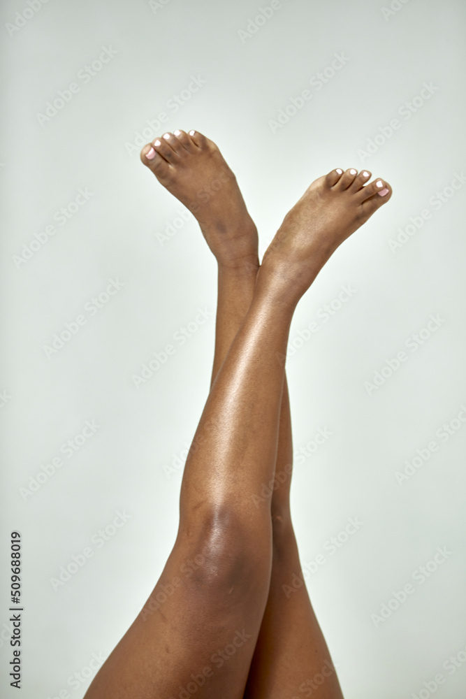 African american female crossed legs raised up. Fat hips. Skin care ...