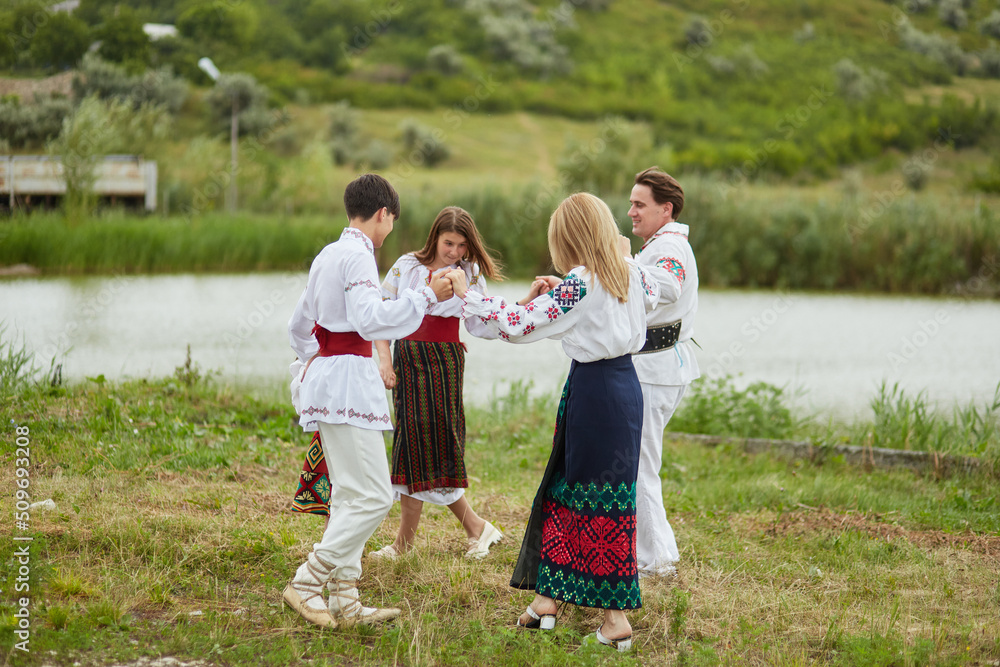 Full length photo of a happy family with kids in traditional romanian ...