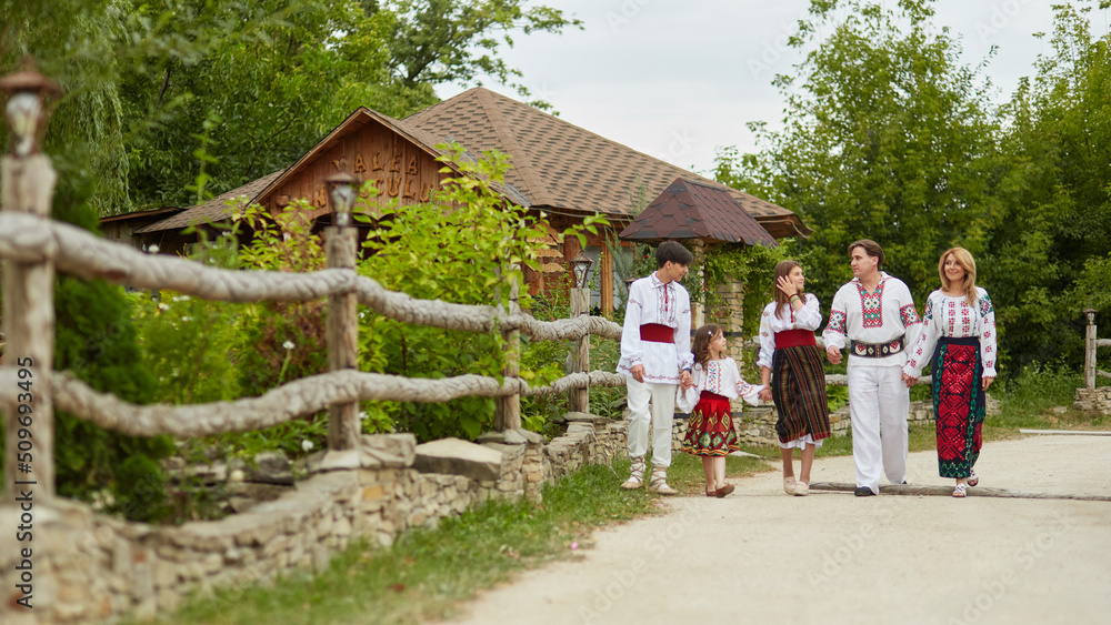 Full length image of a happy family with kids in traditional romanian ...