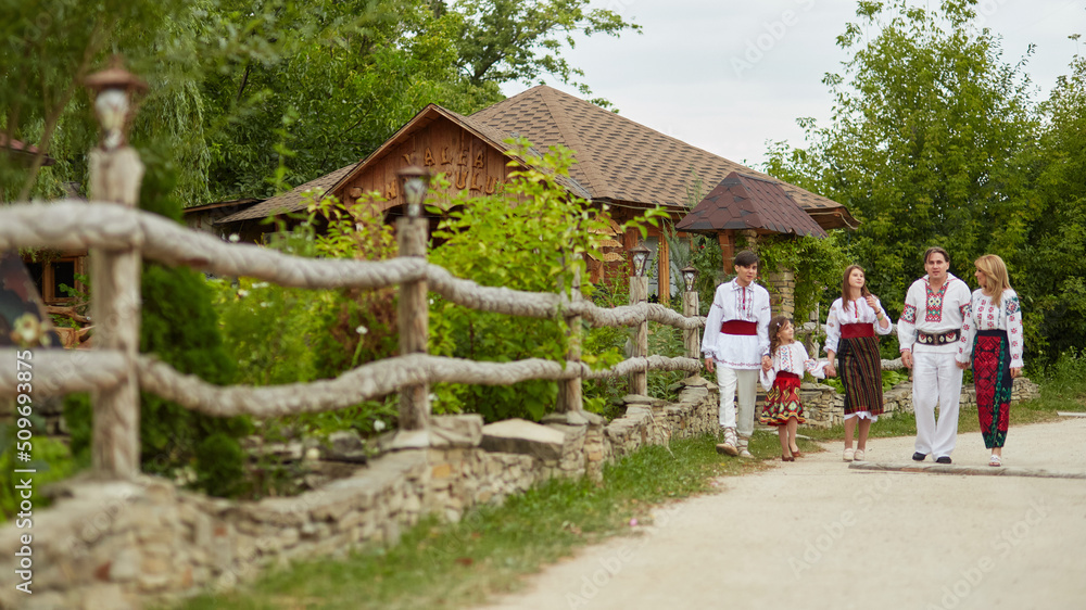 Full length image of a happy family with kids in traditional romanian ...