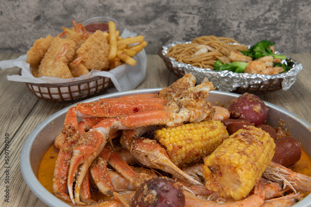 Tempting choice of different seafood with the seasoned boiled snow crab ...