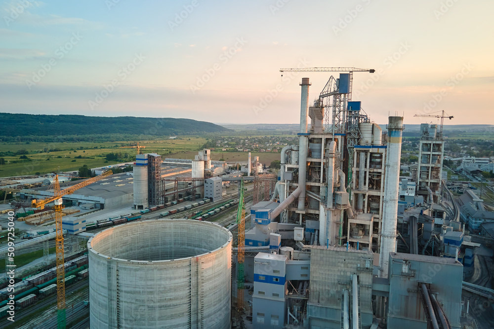 Cement plant with high factory structure and tower cranes at industrial ...