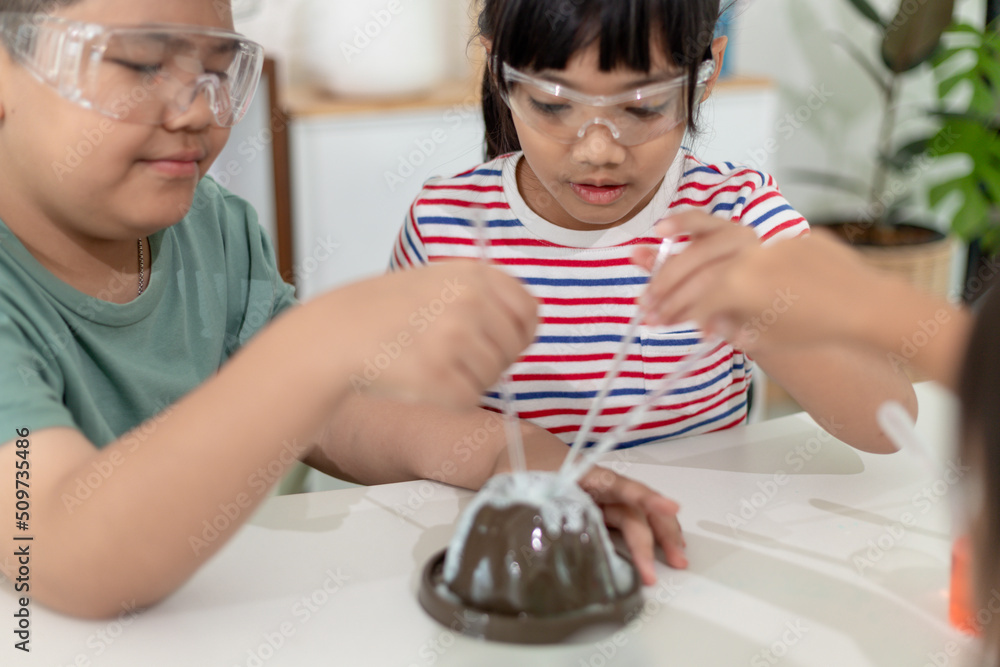 Kids repeating and observing a science lab project at home - the baking ...