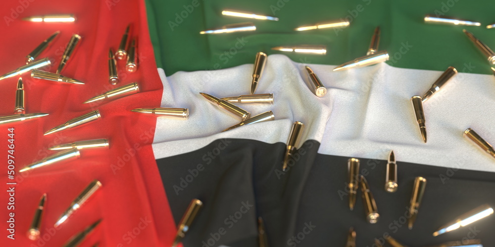 Scattered bullets on the flag of the UAE. Firearms regulation or army ...