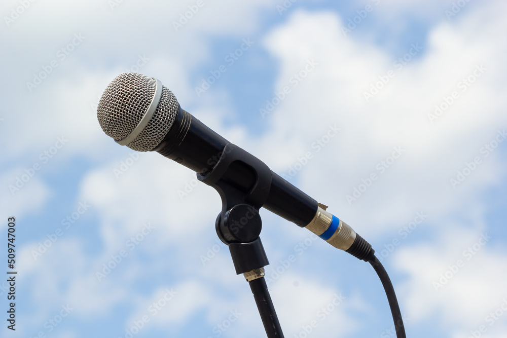 Microphone on sky background. The microphone is on the street. Concept ...