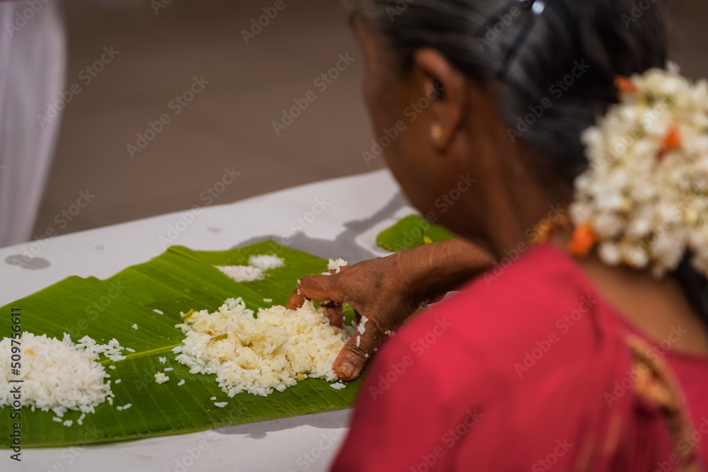 Unrecognizable woman eating traditional South Indian food served on ...