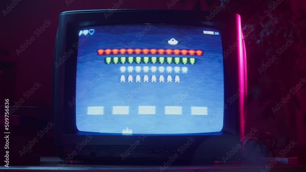 Close Up Footage of a Retro TV Set Screen with an 8 Bit 2D Eighties ...