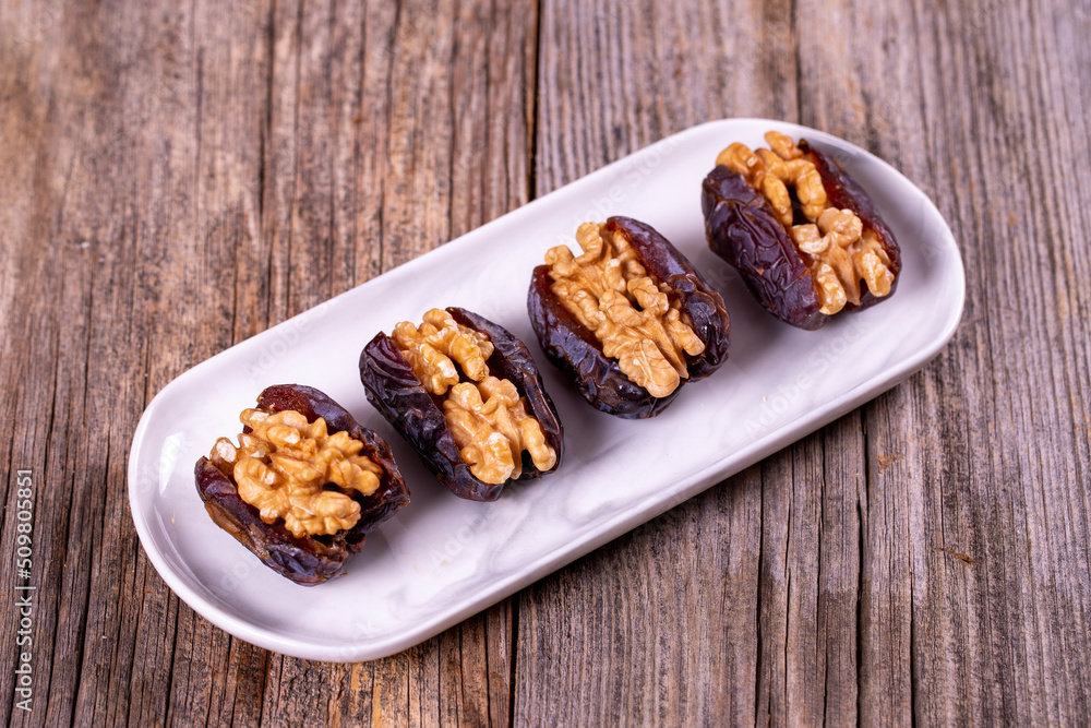 Walnut-stuffed dates on a wood floor. Close-up. Arabian luxury for ...