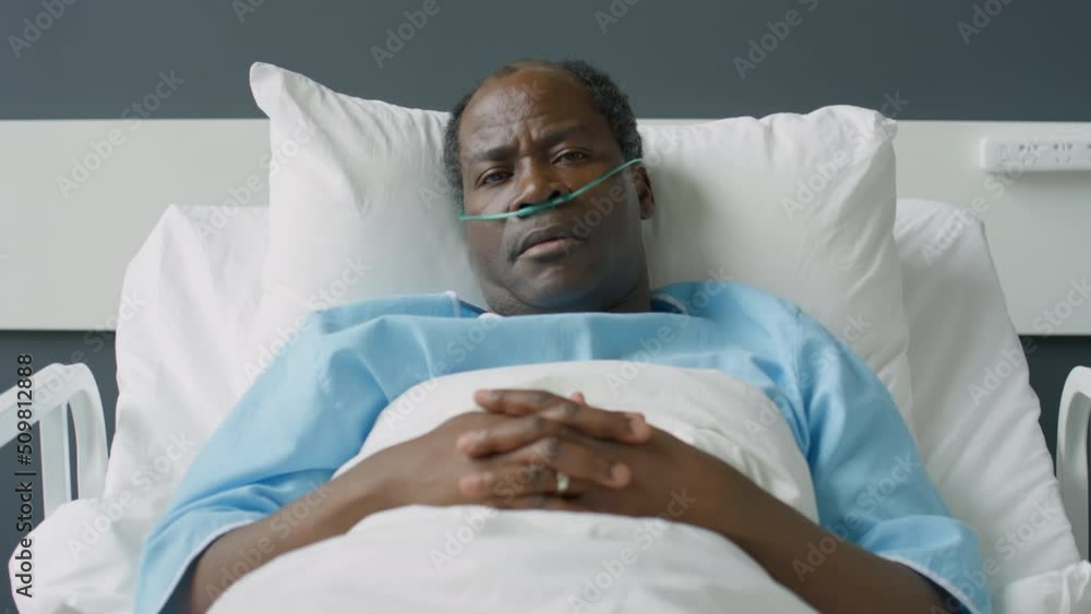 Portrait zoom in shot of sick African American male patient with nasal ...