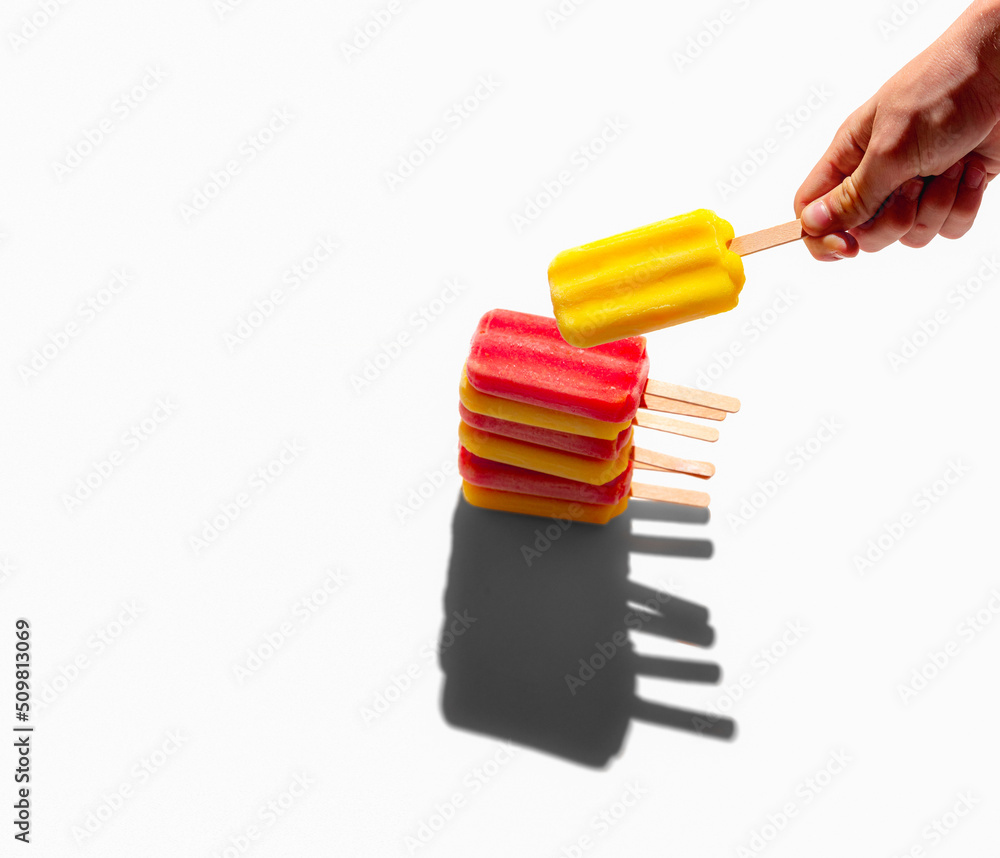 Hand Grabbing a Popsicle from a Stack Stock Illustration | Adobe Stock