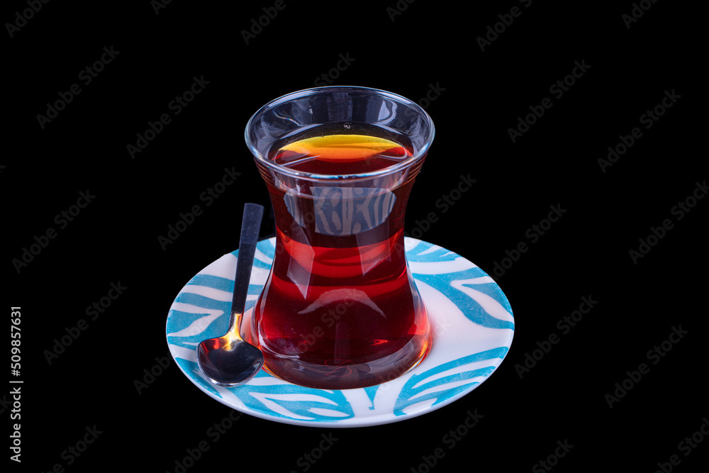Turkish tea served in traditional glass isolated on black background ...