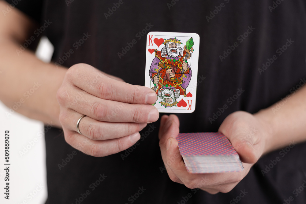 Male hands hold a deck of cards and show tricks. The photographer is ...
