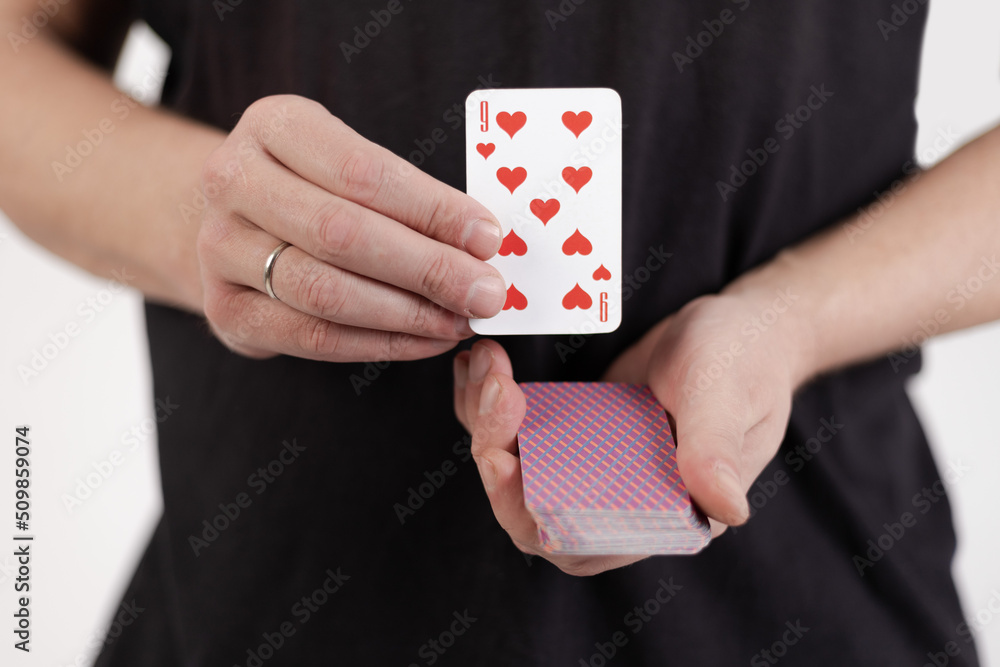Male hands hold a deck of cards and show tricks. The photographer is ...