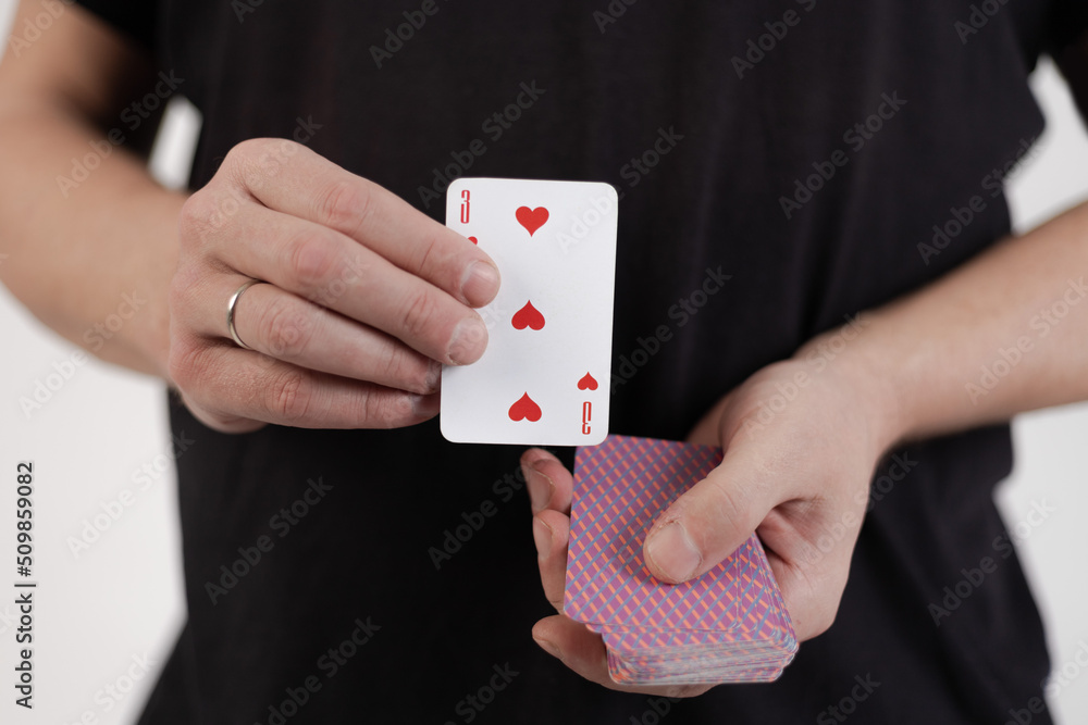 Male hands hold a deck of cards and show tricks. The photographer is ...
