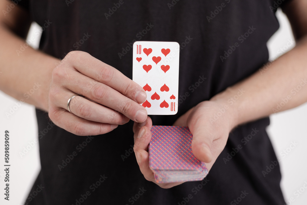 Male hands hold a deck of cards and show tricks. The photographer is ...