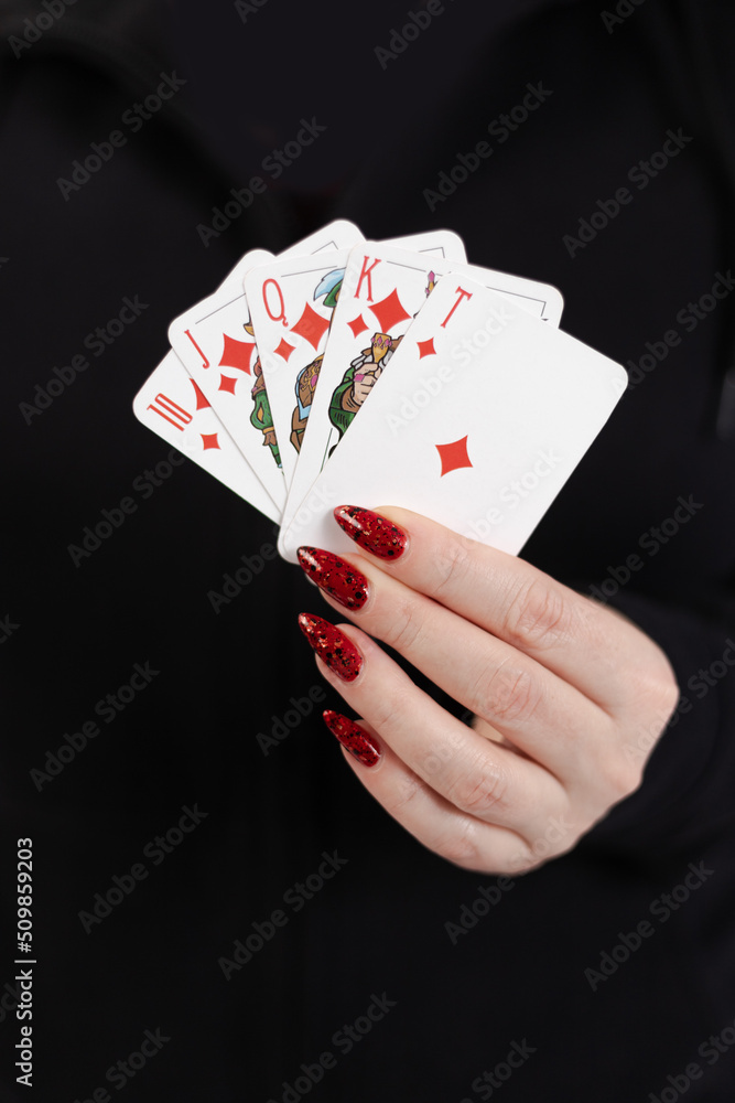 Female hands hold a deck of cards and show tricks. The photographer is ...