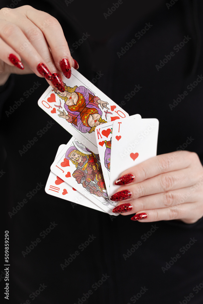 Foto de Female hands hold a deck of cards and show tricks. The ...