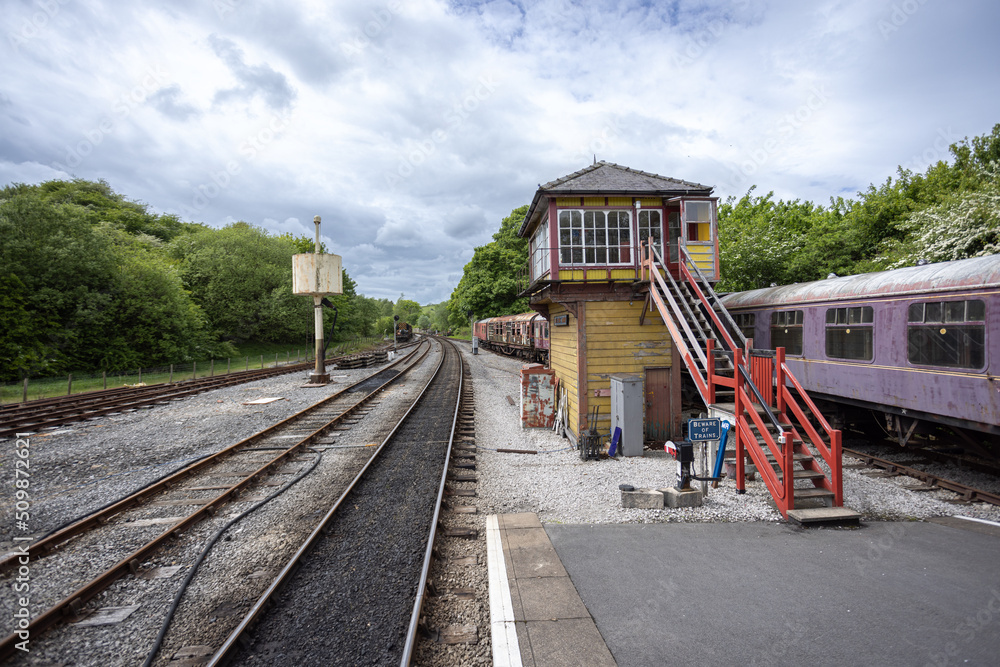 Old train platform, tracks and yellow wooden structure at Bolton Abbey ...