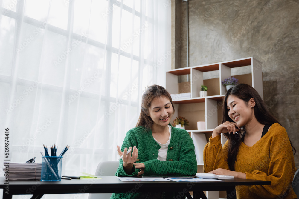 Young business women working on paperworks and tablet with happy and ...