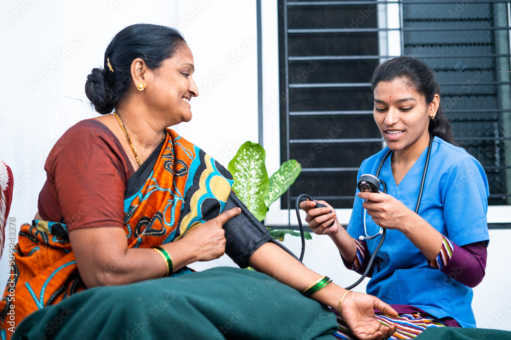 focus on doctor, Nurse checking BP or blood pressure of sick woman ...