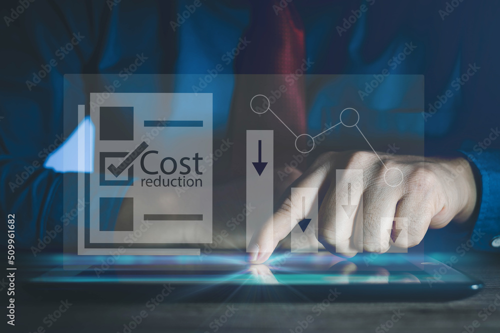 Cost reduction Concept. Businessman with his hand lowers the arrow of the graph. Cost text with ...