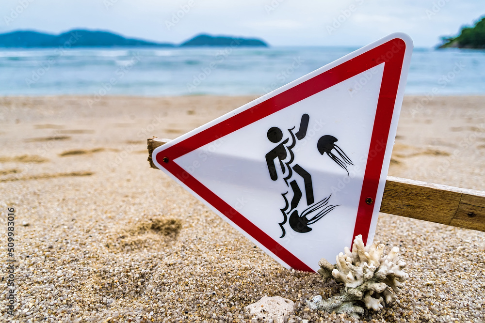 Warning sign for swimming in the sea, beware of jellyfish, placed on ...