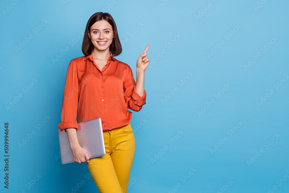 Portrait of attractive cheerful skilled girl holding laptop showing ...