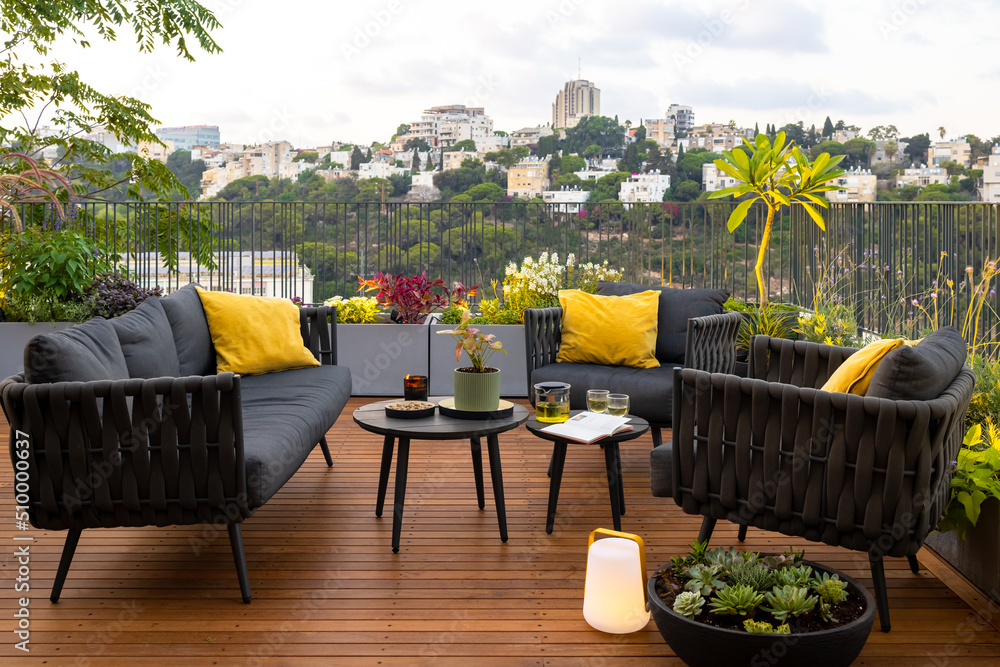 Amazing sun terrace with sofa armchairs, coffee tables, flower pots ...