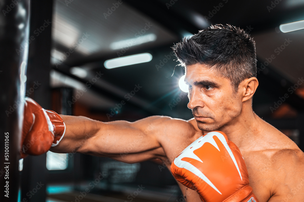Sportsman muay thai boxer fighting in gloves boxing cage. Professional ...