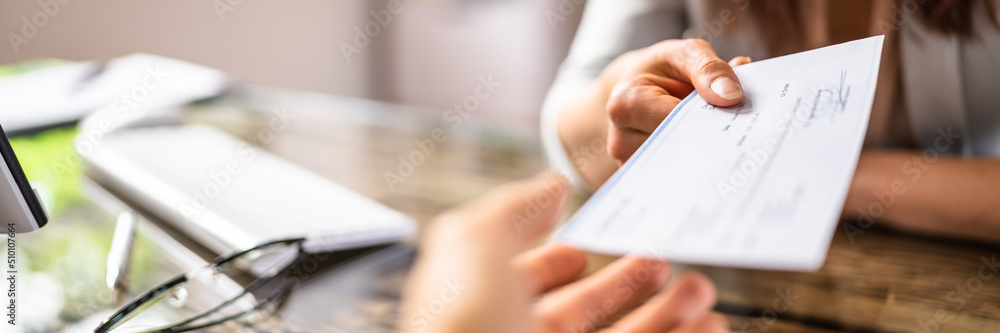 Businesswoman Giving Cheque To Her Colleague Stock Photo | Adobe Stock