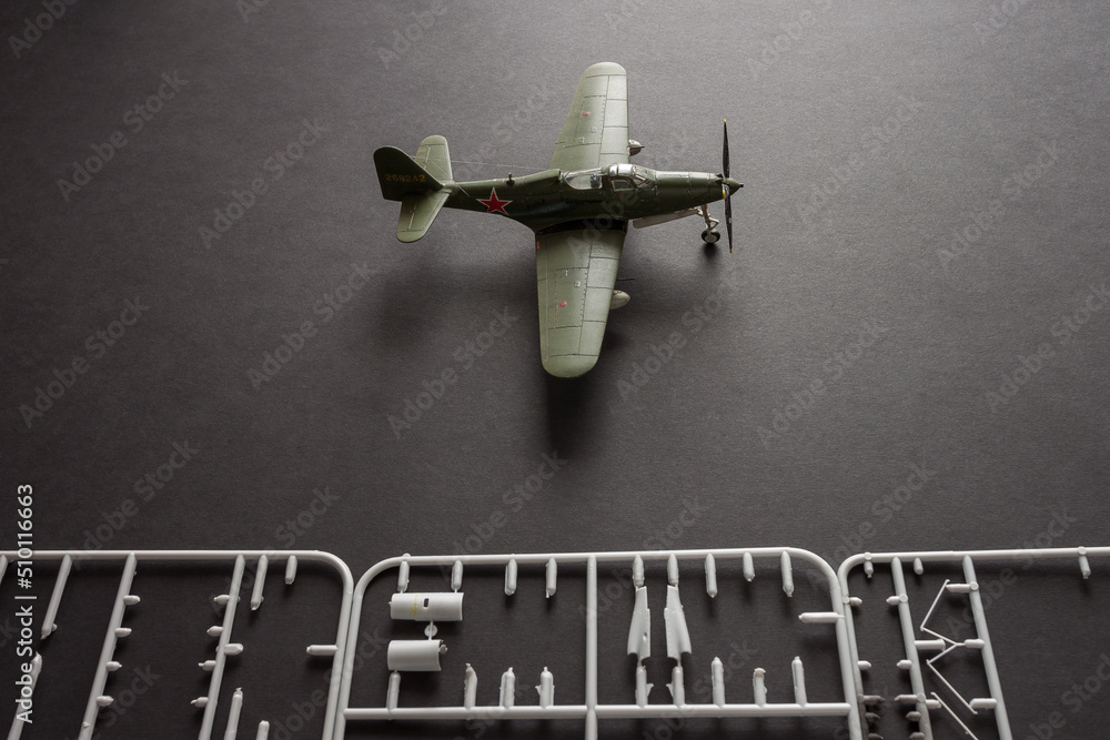 Scale model of a fighter aircraft with details and tools. Plastic ...