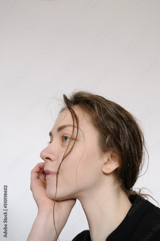profile portrait of a girl with a smirk on her face and collected hair ...