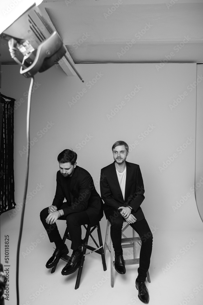 black and white photo of guys in the studio sitting on chairs on a ...