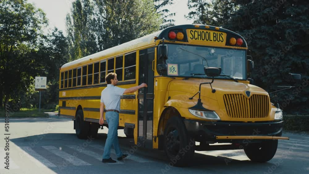 Man driver coming up schoolbus press button alone. Operator enter ...