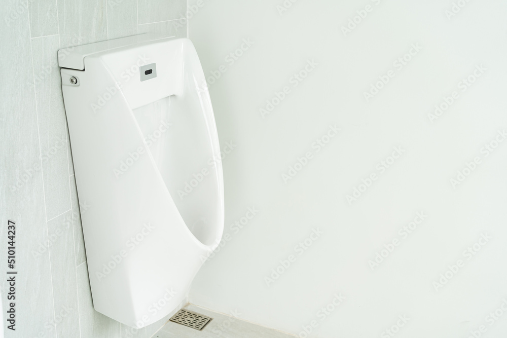 White urinal in the restroom. white ceramic urinal chamber pot interior ...