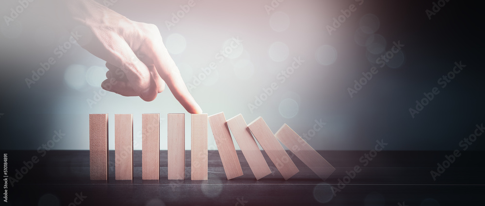 cube blocks stop falling blocks on table. Stock Photo | Adobe Stock