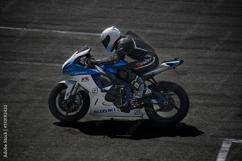 12-09-2022 Riga, Latvia man riding motorcycle in asphalt road ...