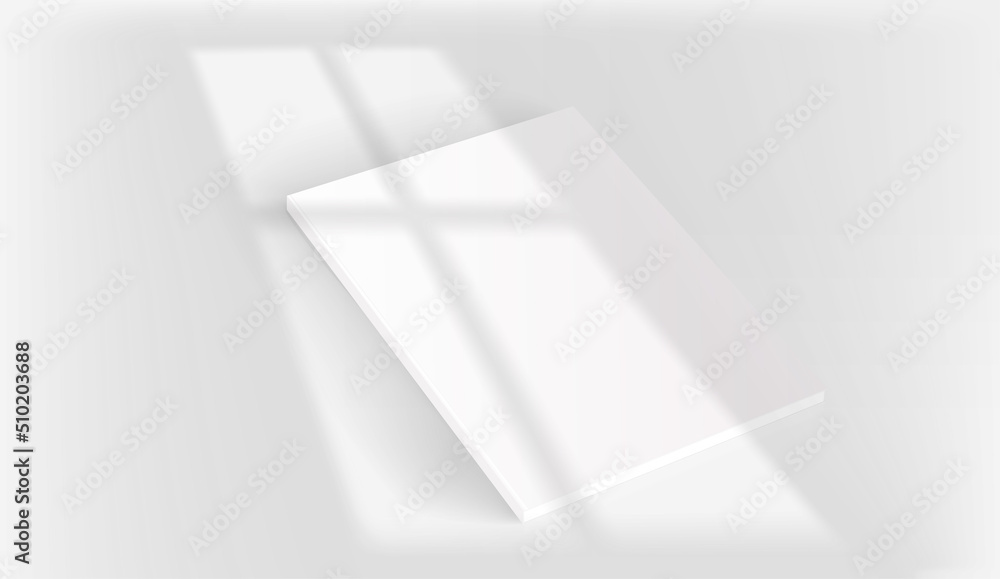White book on a table with light of the window shadow overlay ...