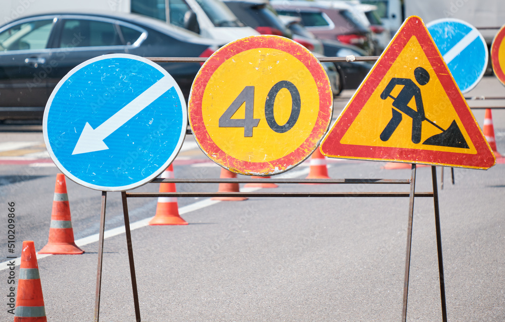 Road signs, and traffic cones with orange and white stripes in ...