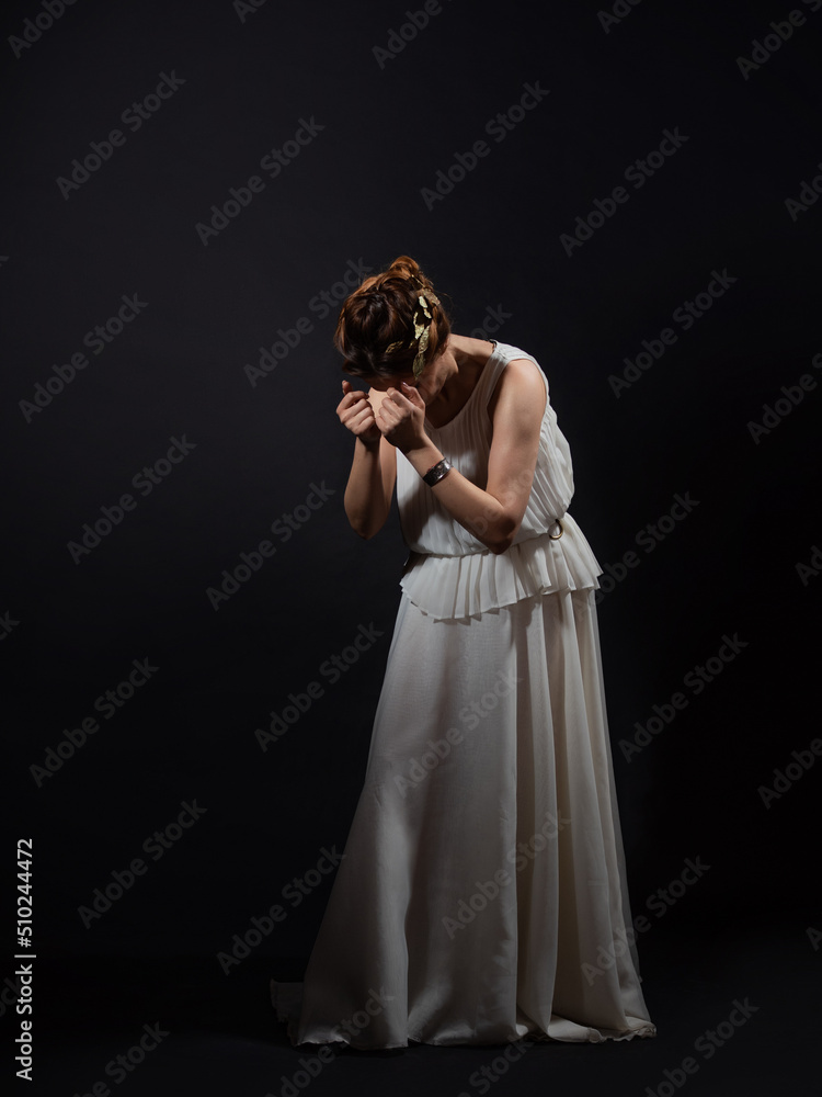 The heroine of an ancient tragedy in grief and loss. A young woman in a ...