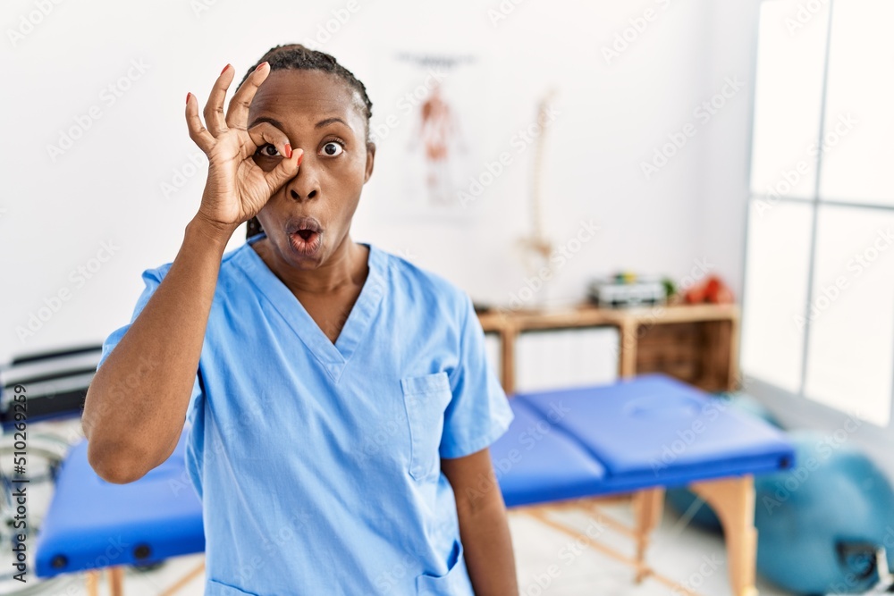 Black woman with braids working at pain recovery clinic doing ok ...