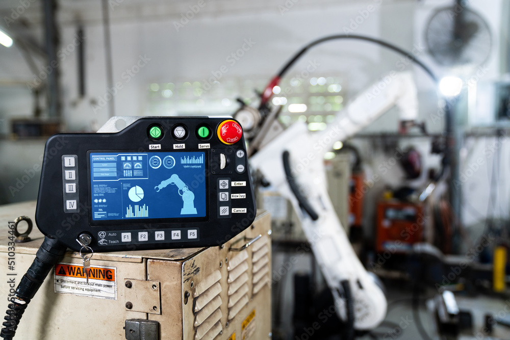 Robotic arm and its controller adept panel in a factory workshop ...