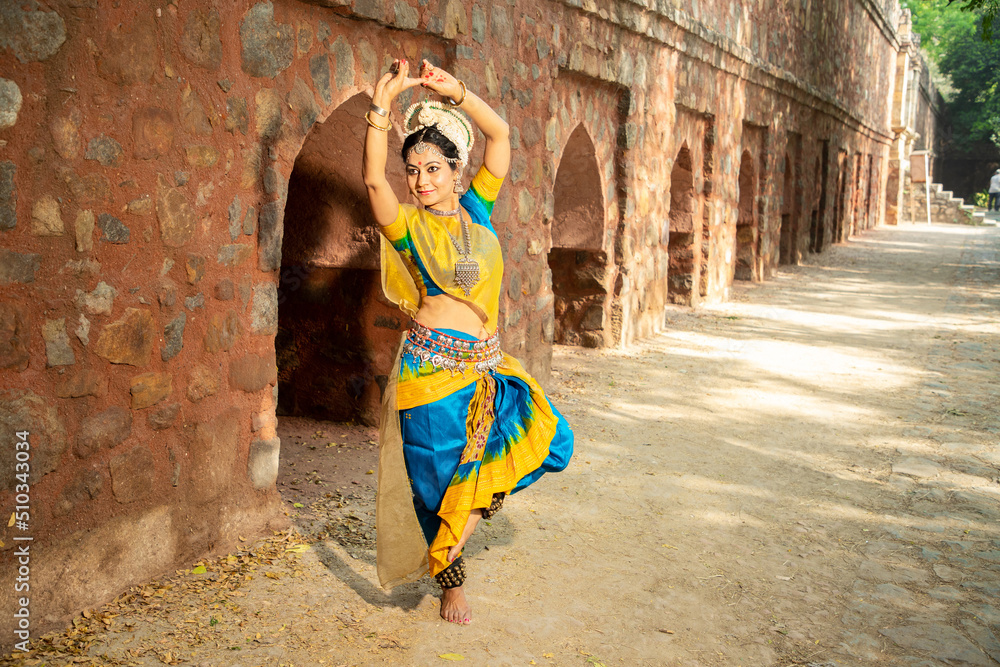 Indian woman Odissi dancer doing classical dance form outdoor at ...